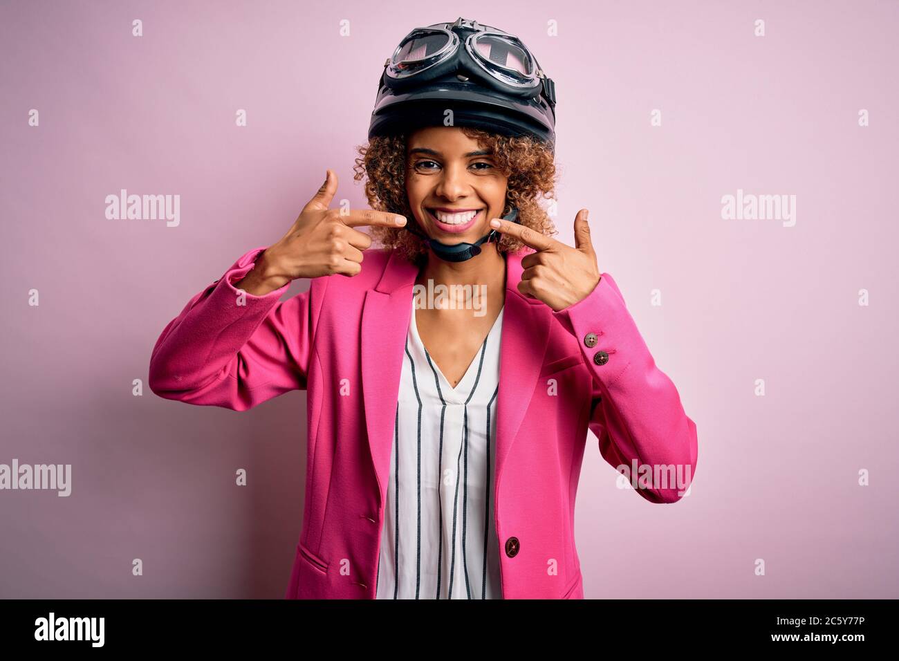 African american motorcyclist woman with curly hair wearing moto helmet ...
