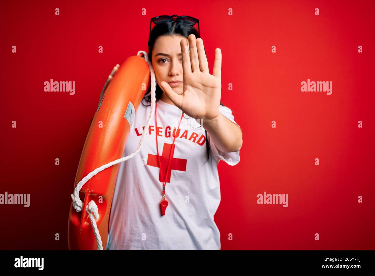 Young lifeguard woman wearing secury guard equipent holding rescue ...