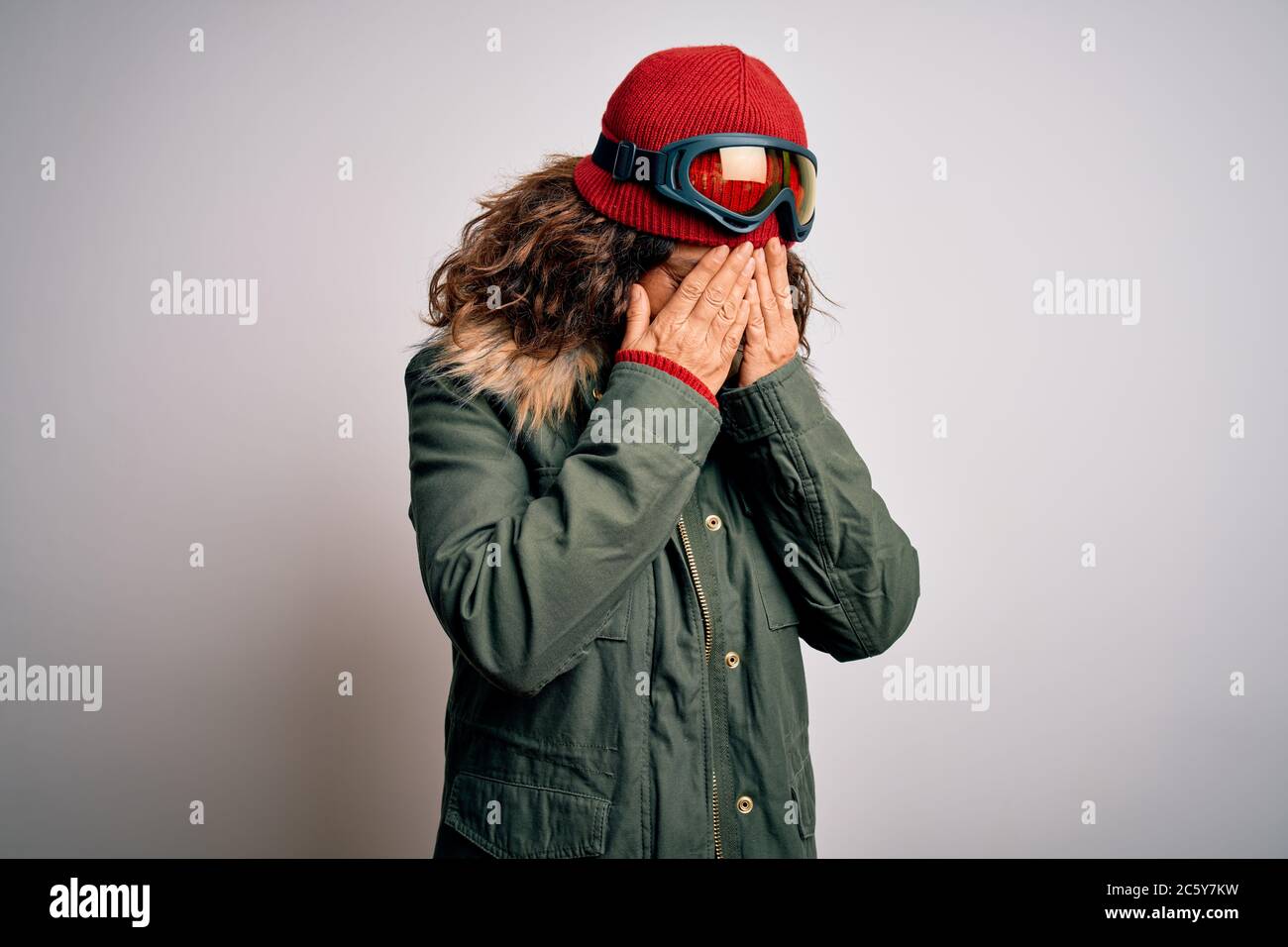 Middle age skier woman wearing snow sportswear and ski goggles over ...