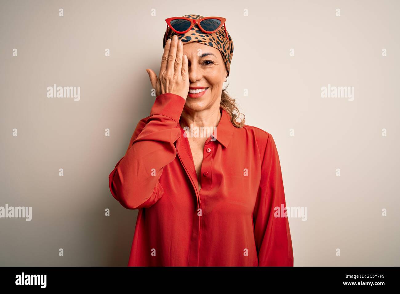 Middle age brunette woman wearing handkerchief on head and shirt over ...