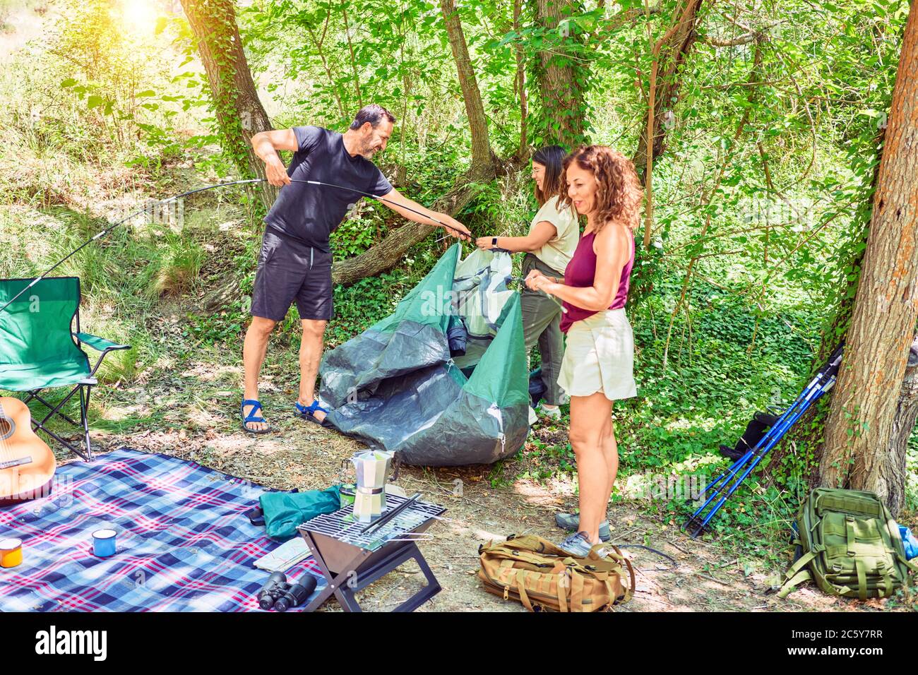 Family of hiker setting up the tent to camping at the forest Stock ...