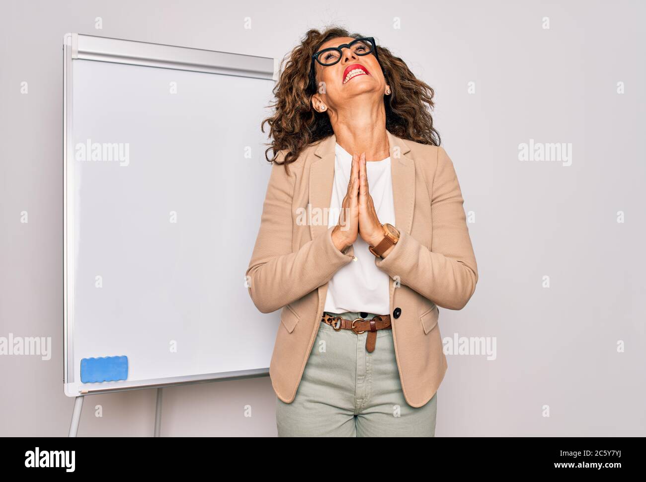 Middle age senior business woman standing on seminar presentation by ...