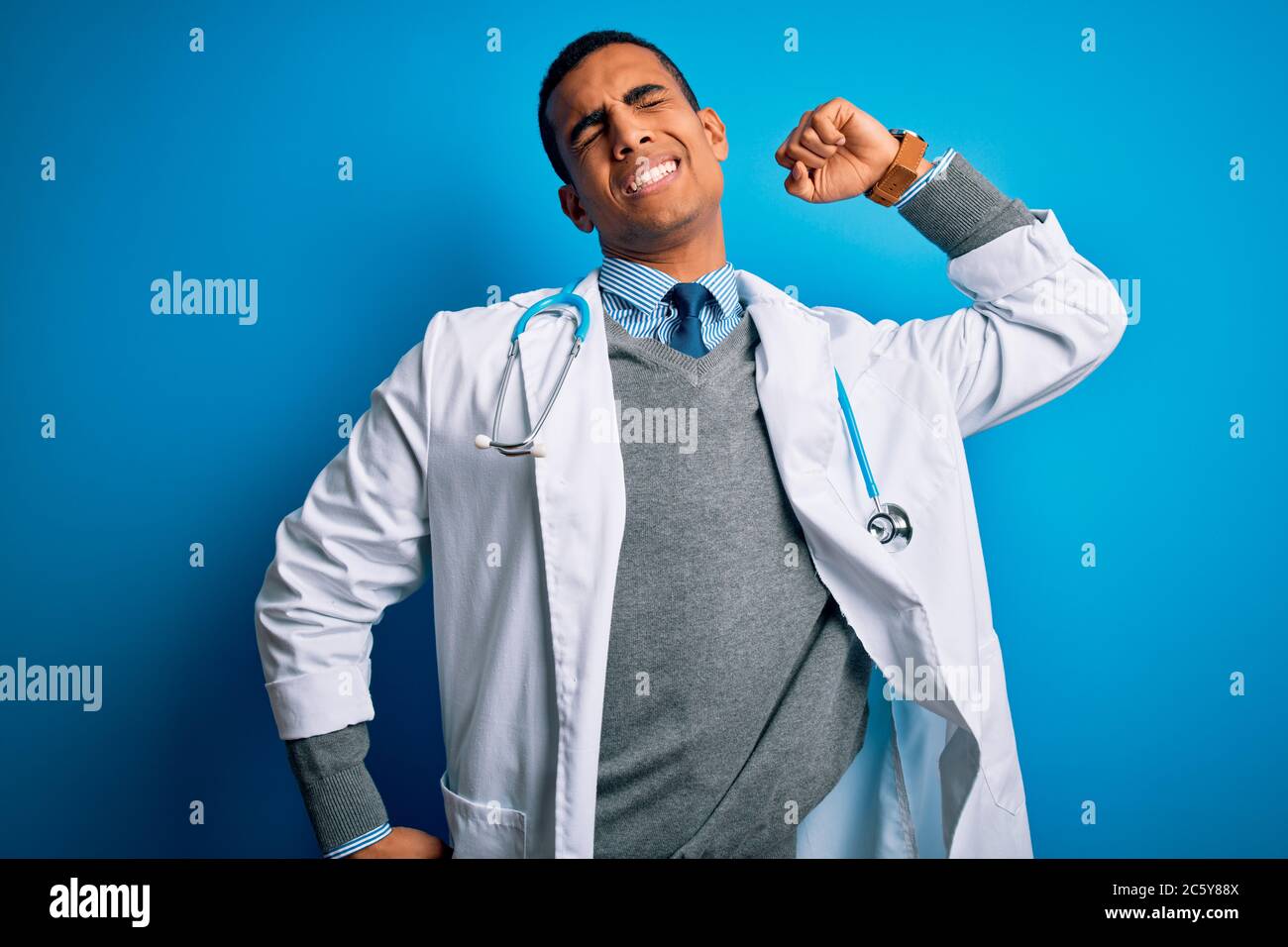Handsome african american doctor man wearing coat and stethoscope over ...