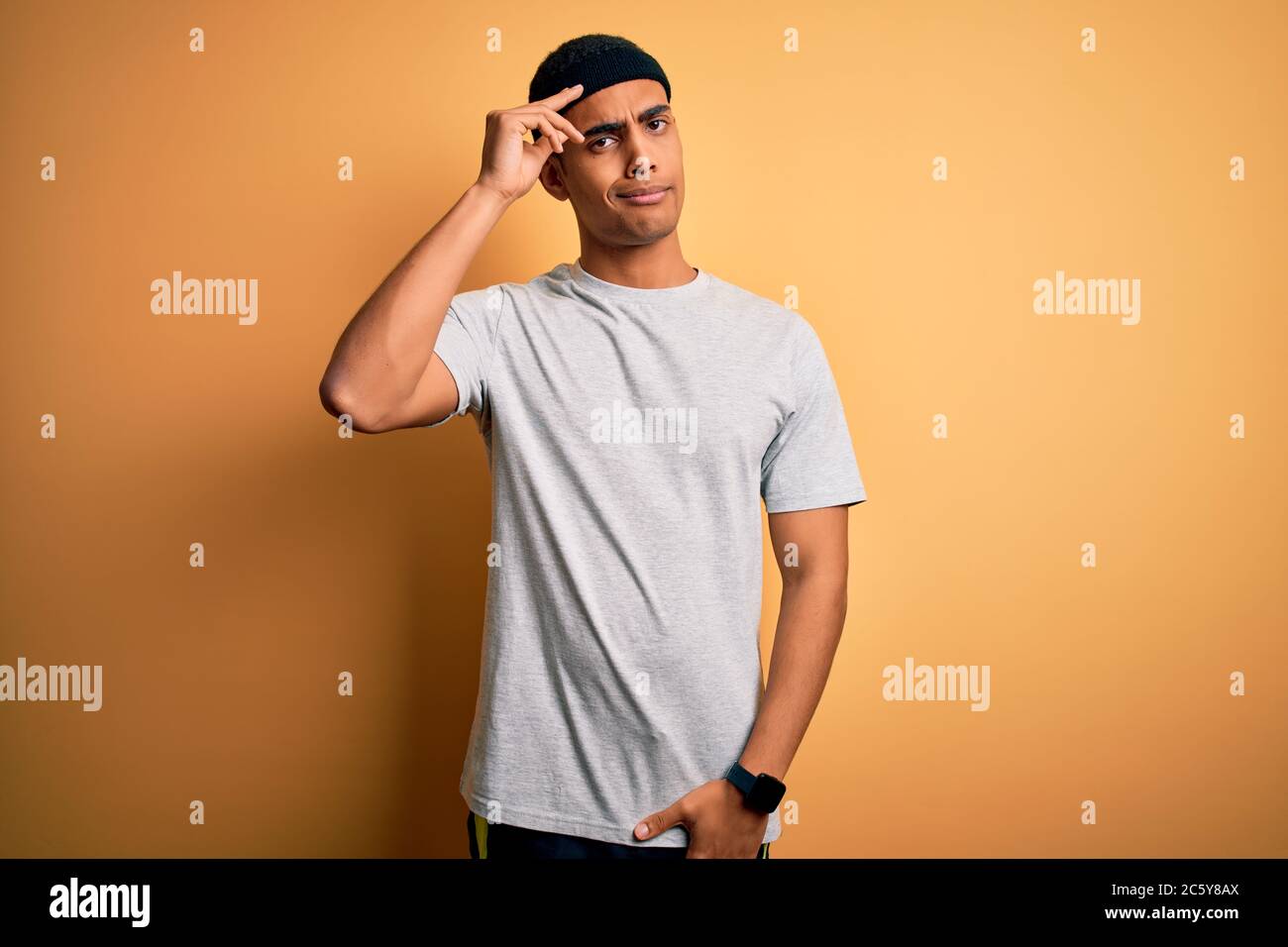 Handsome african american sportsman doing sport wearing sportswear over ...