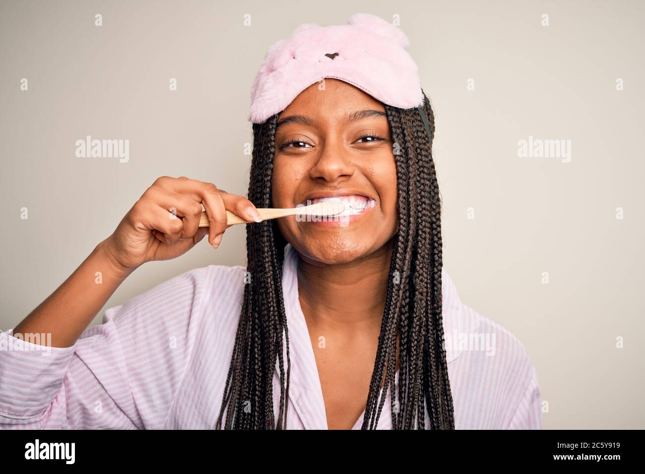 Young beautiful african american woman wearing pajama and sleep mask ...