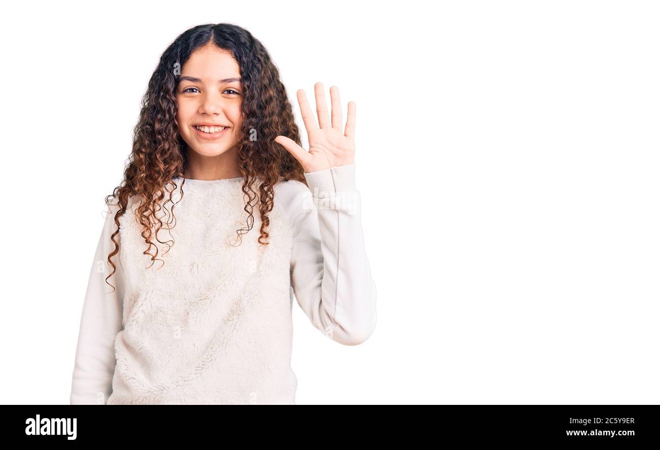 Beautiful kid girl with curly hair wearing casual clothes showing and ...