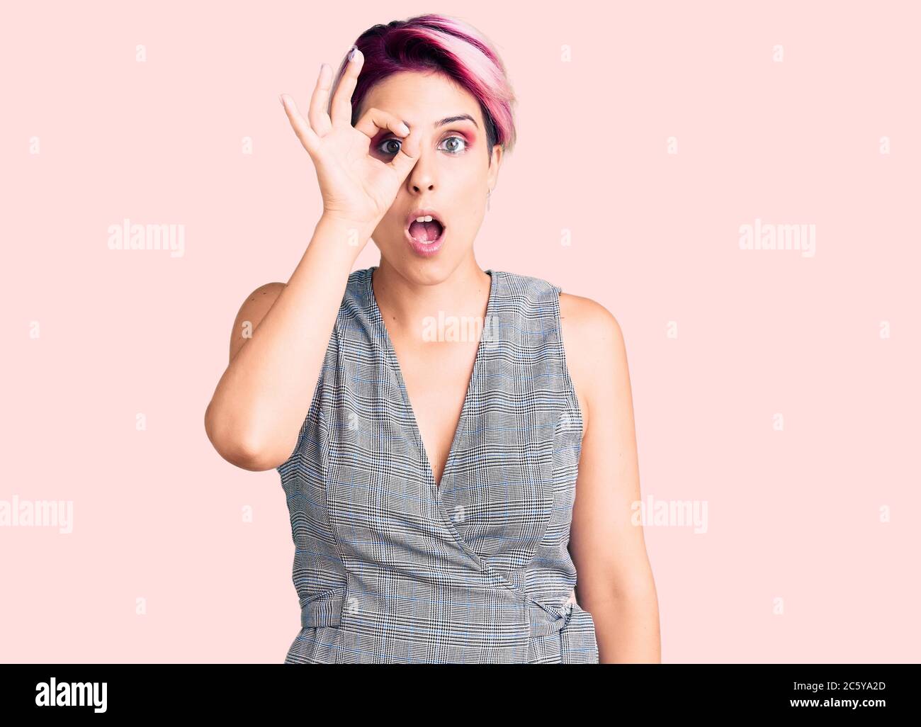 Young beautiful woman with pink hair wearing casual clothes doing ok ...