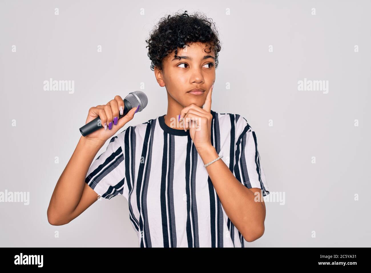 Beautiful african american afro singer woman singing using microphone ...