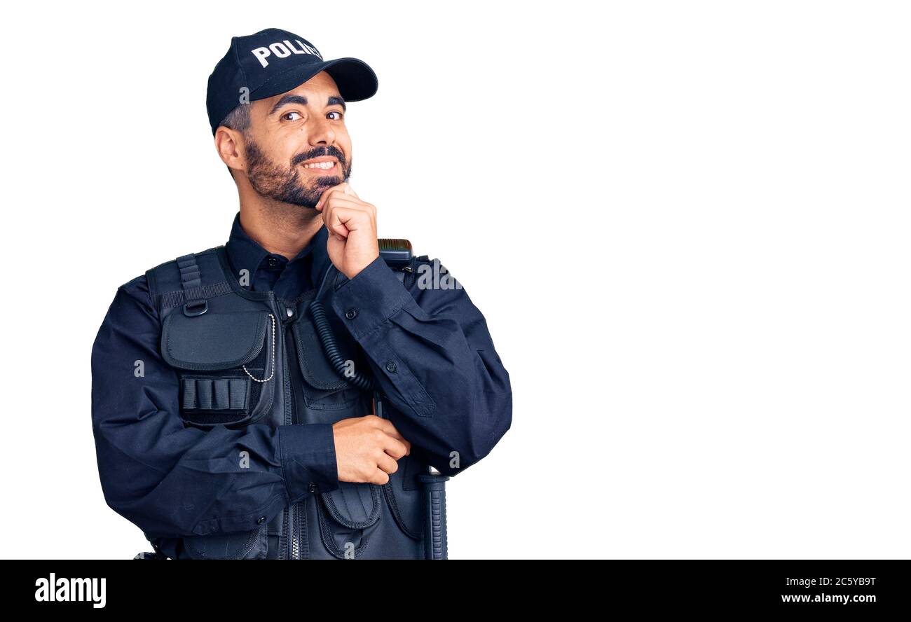 Young hispanic man wearing police uniform looking confident at the ...