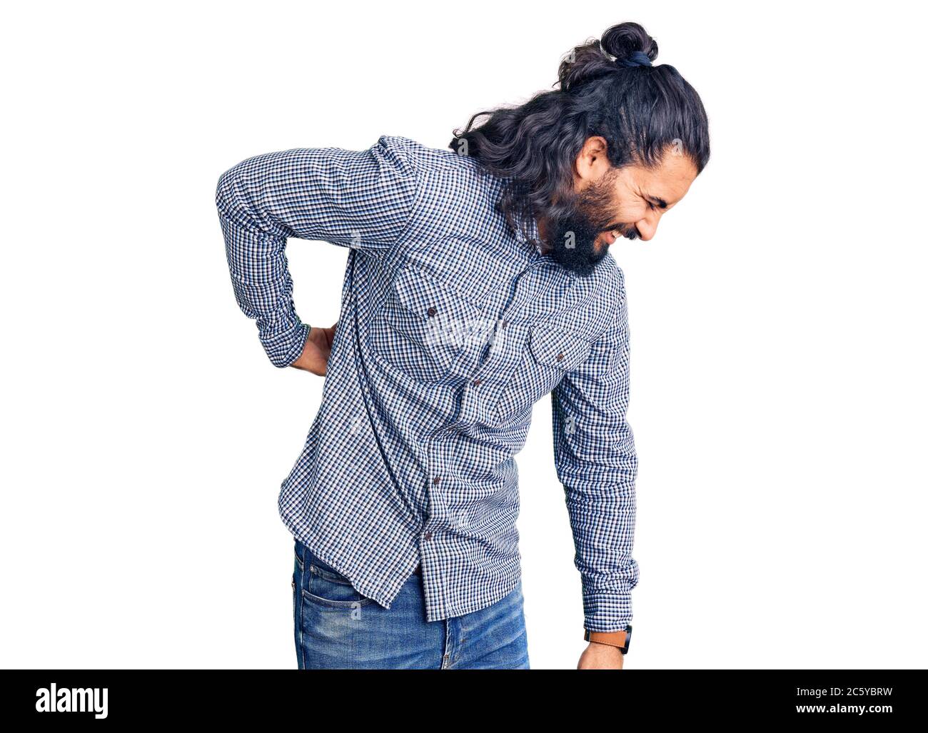 Young arab man wearing casual clothes suffering of backache, touching ...