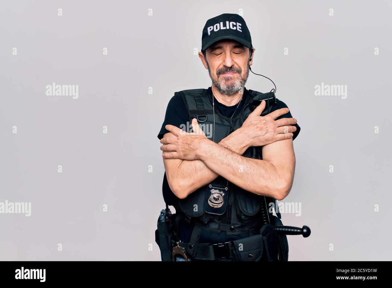Middle age policeman wearing police uniform and bulletproof vest over ...