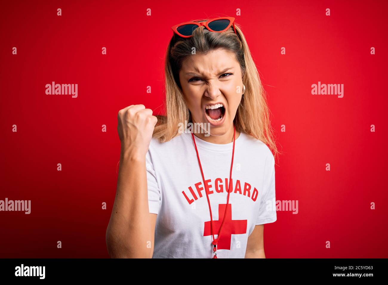 Young beautiful blonde lifeguard woman wearing t-shirt with red cross ...