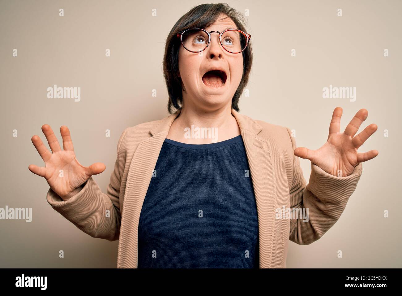 Young down syndrome business woman wearing glasses standing over ...