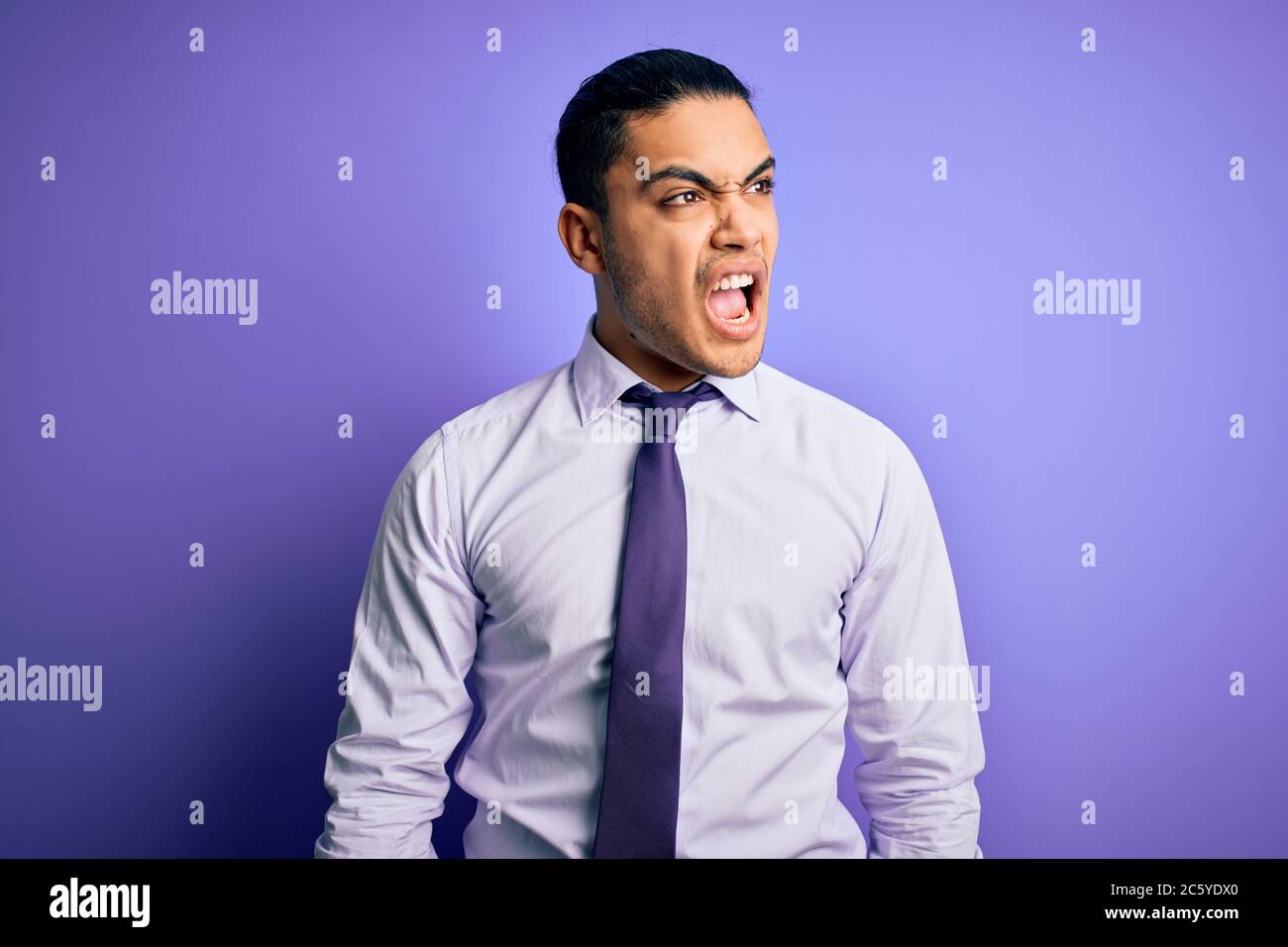 Young brazilian businessman wearing elegant tie standing over isolated ...
