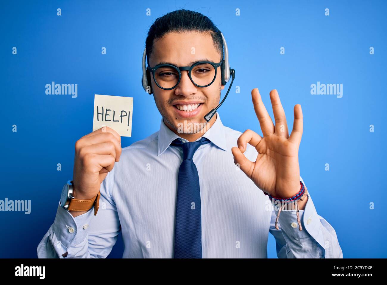 Young brazilian call center agent man overworked holding reminder paper ...