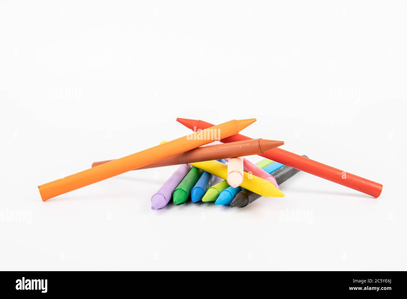 Colored pastel crayons on a white background. creativity, learning ...