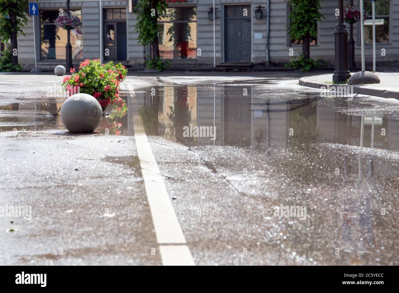 Streets after heavy summer rain with puddles, extrem wather and urban ...