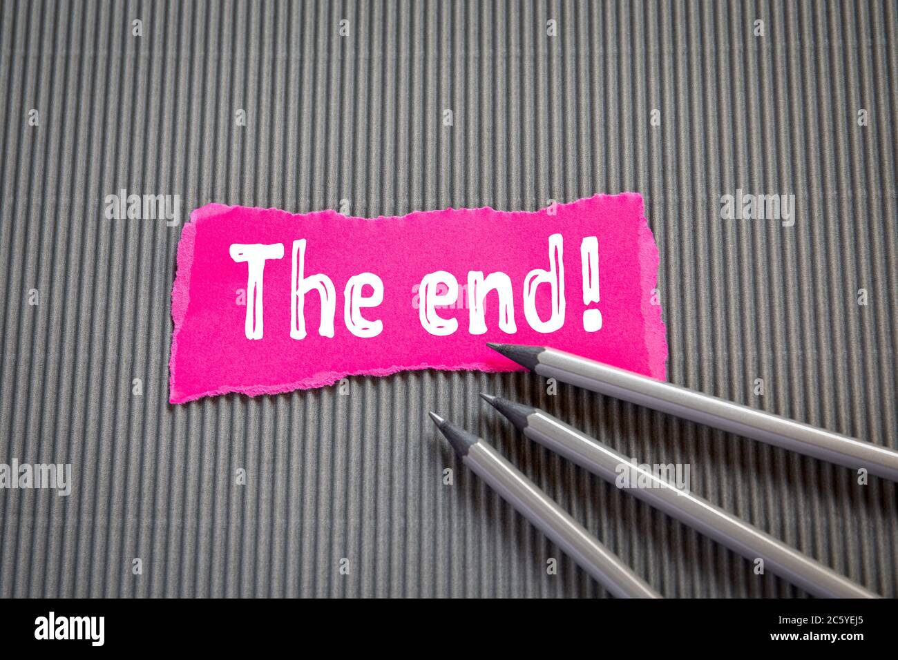 THE END. Text on torn, pink paper on corrugated background Stock Photo ...