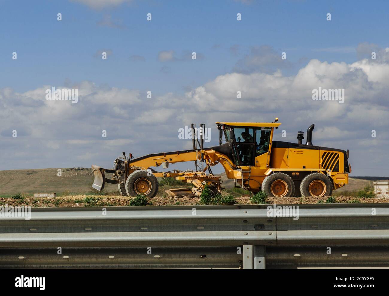 Grader yellow. Grader road construction, industrial machine for the ... Grader yellow. Grader road construction, industrial machine for the ...