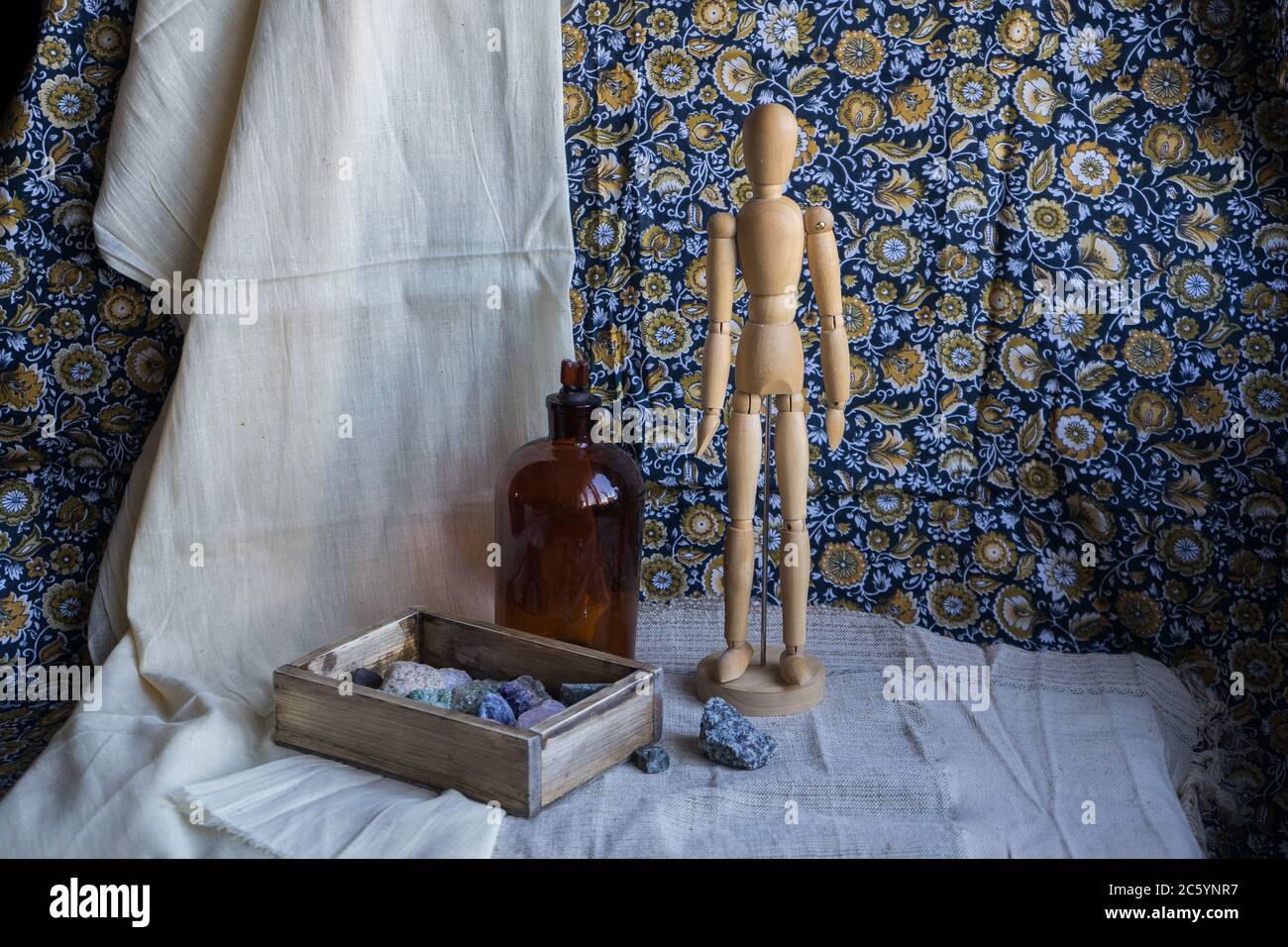 Still life with precious stones, a wooden man and a vintage jar Stock ...