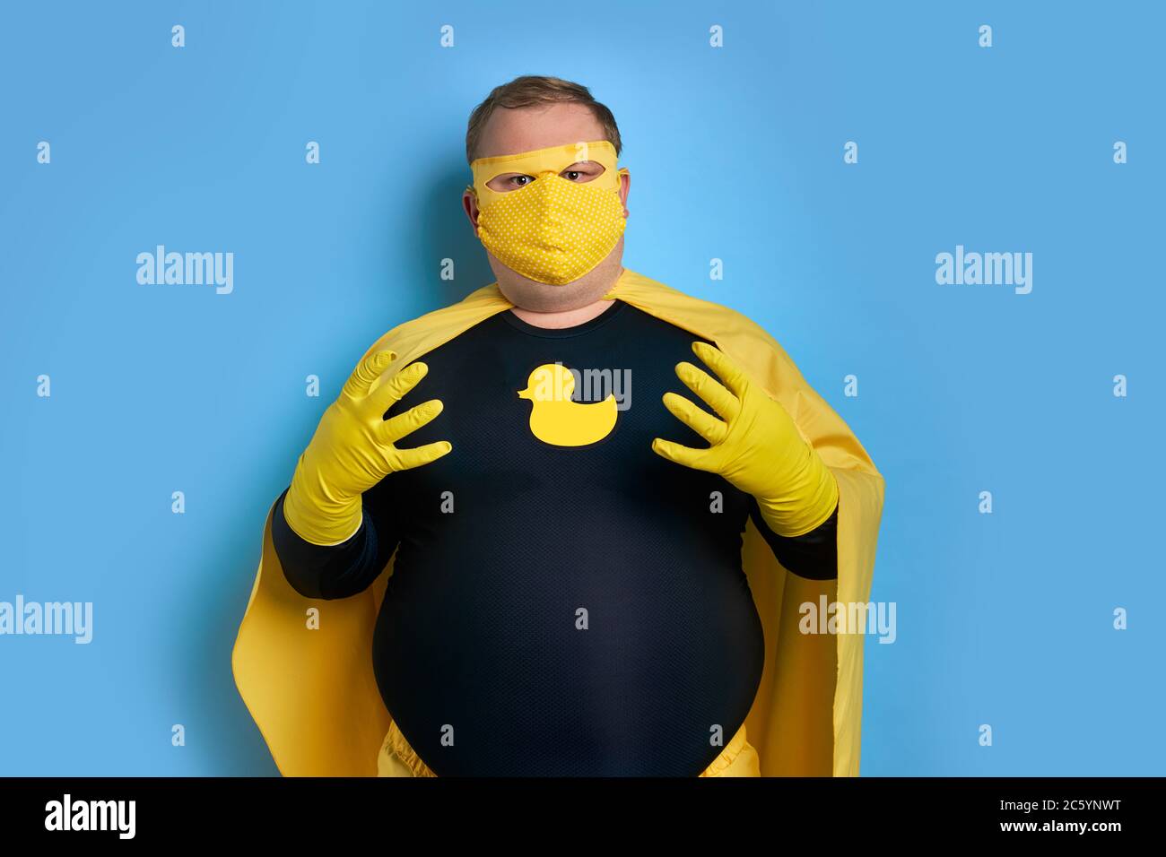 young caucasian fat cleaning man in costume of superhero and in mask ...