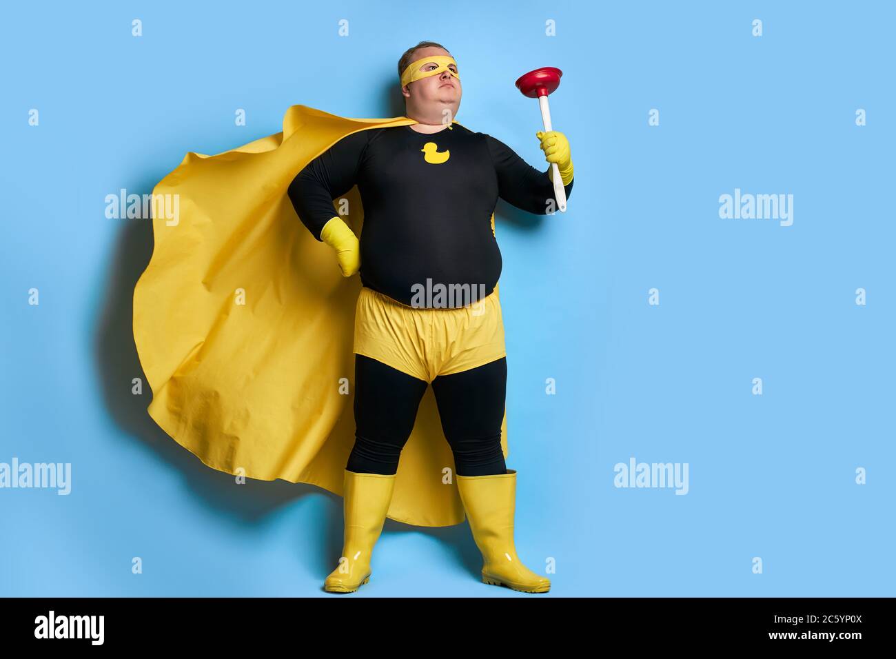 portrait of funny cheerful fat man with plunger in hands, man is ready ...