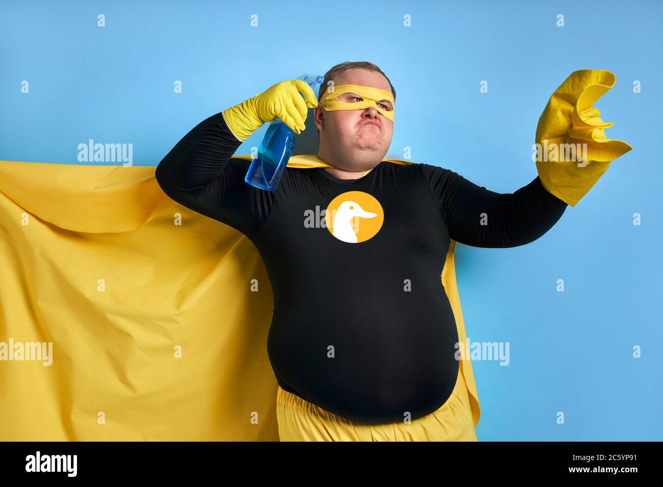 angry caucasian fat man in yellow costume applies detergent at rag, he ...
