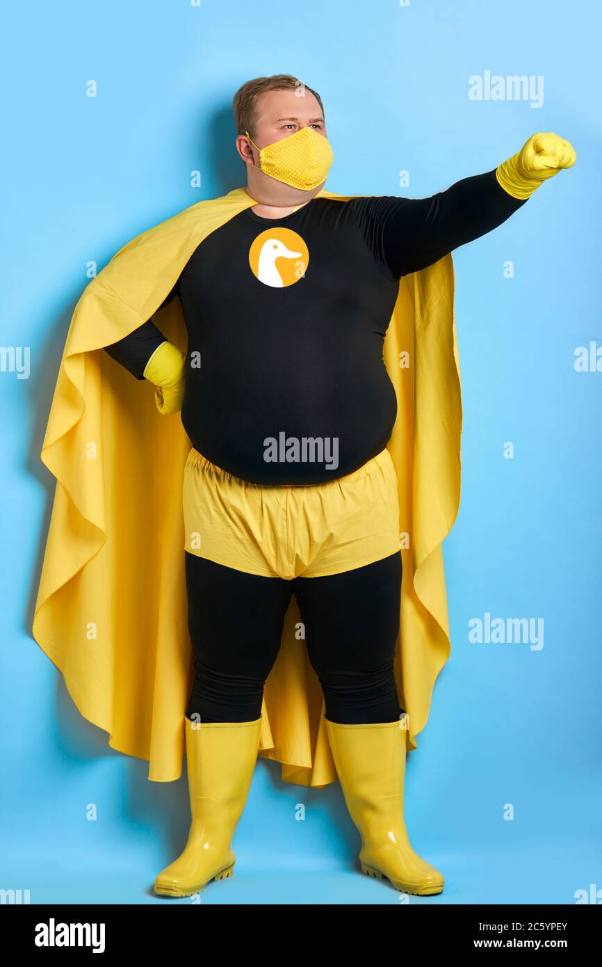 portrait of enthusiastic cleaning superhero isolated over blue ...