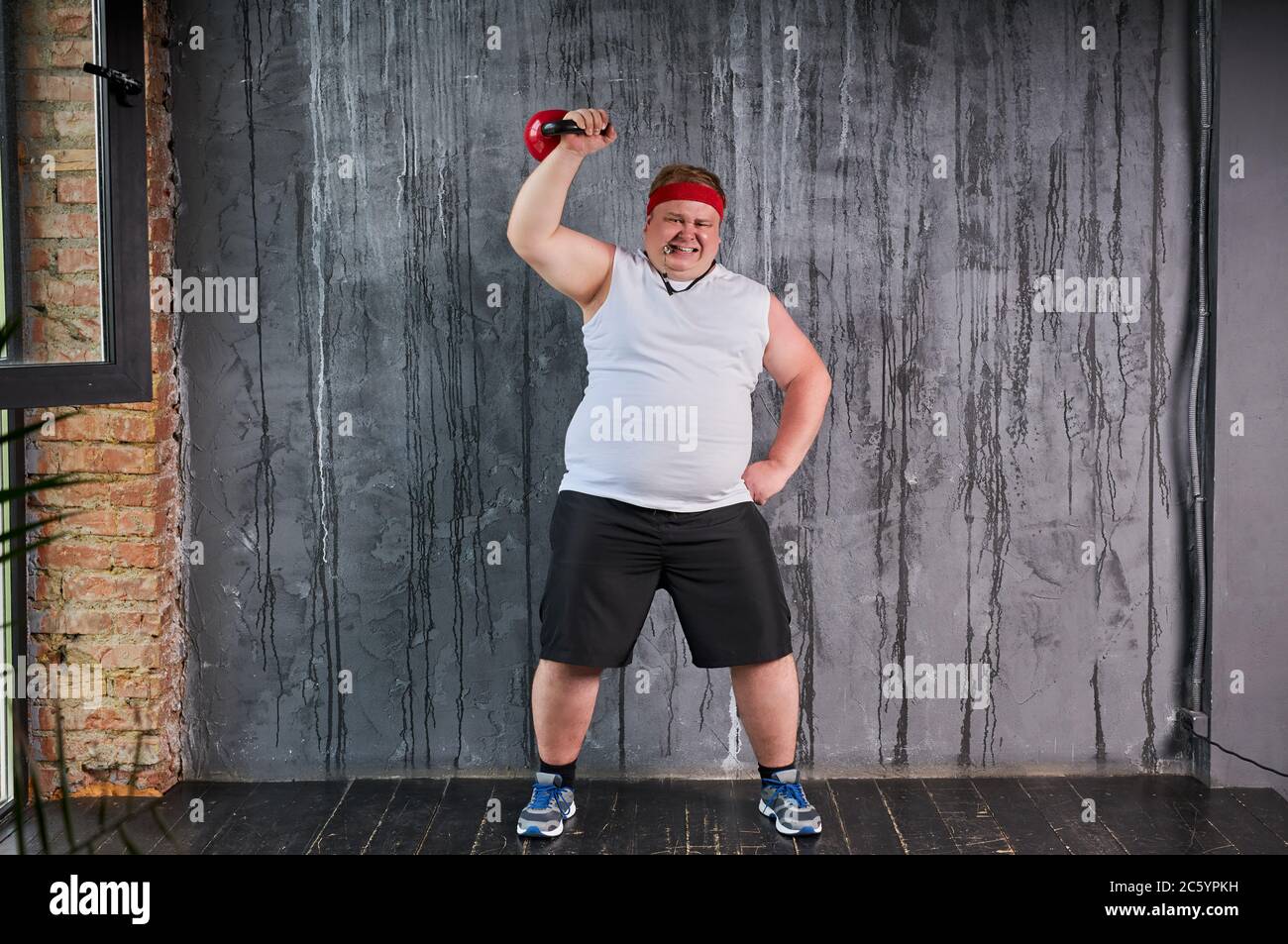 fat caucasian sporty man with weight for training in hands, man is ...