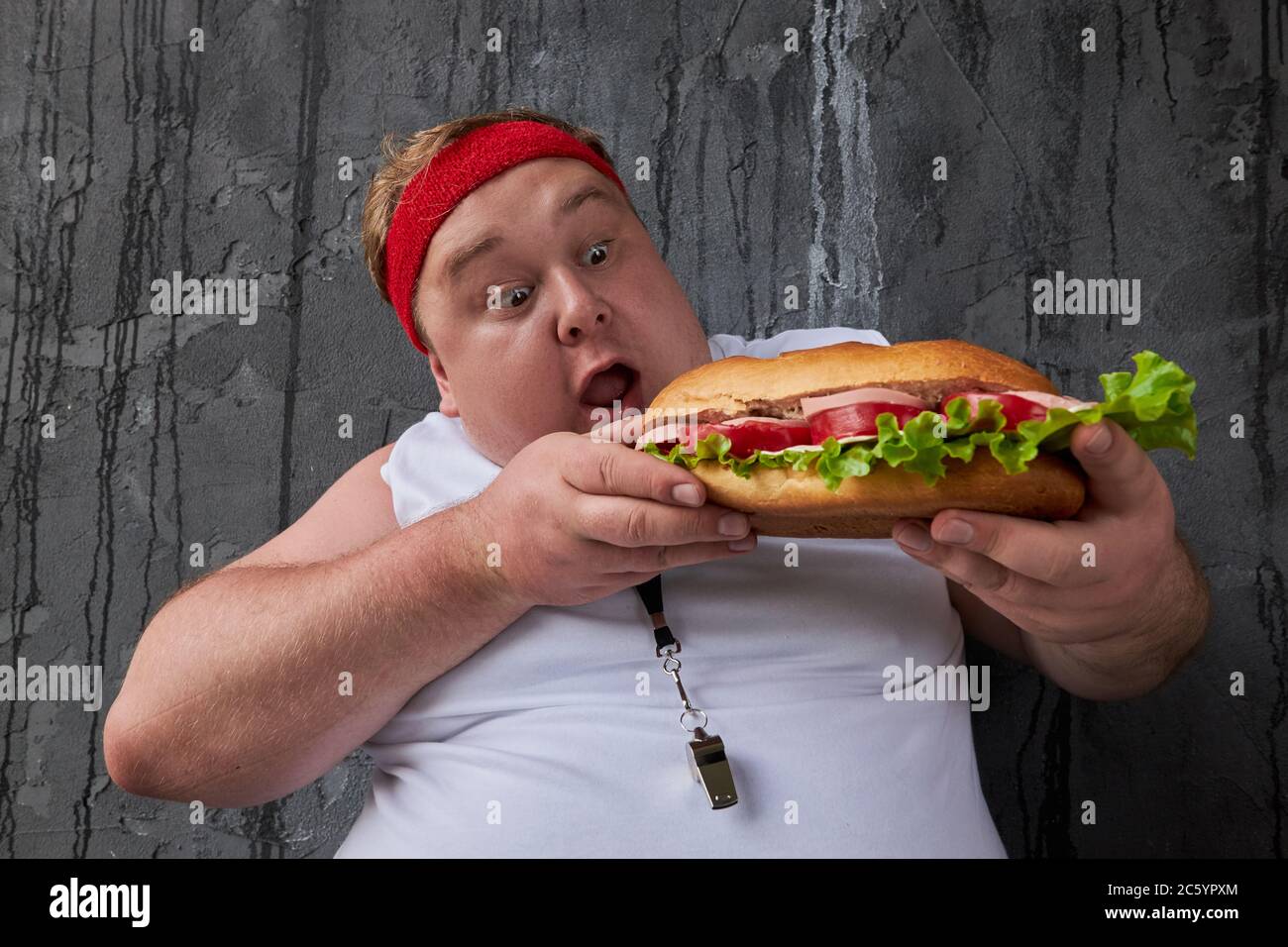 fat funny man opened his mouth to bite off a tidbit of a sandwich ...