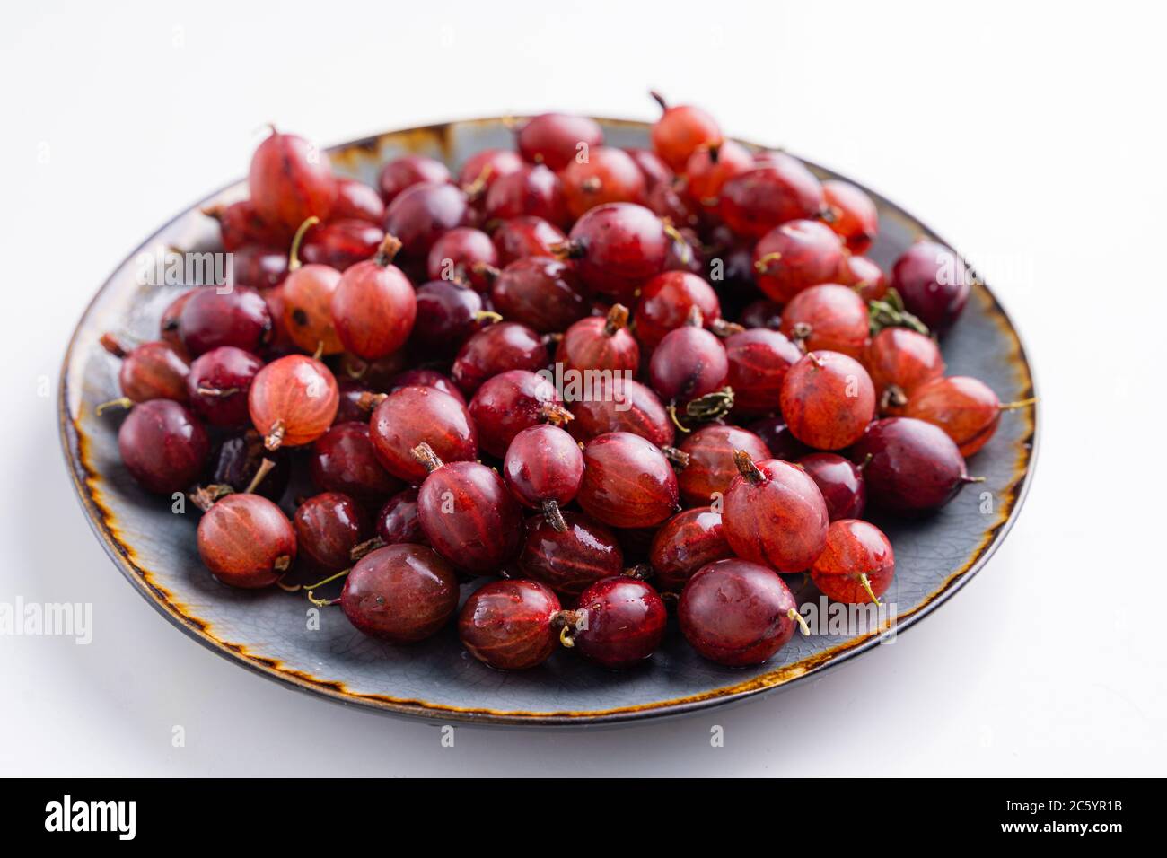 Close up shot of red gooseberry harvest. Healthy lifestyle and eating ...