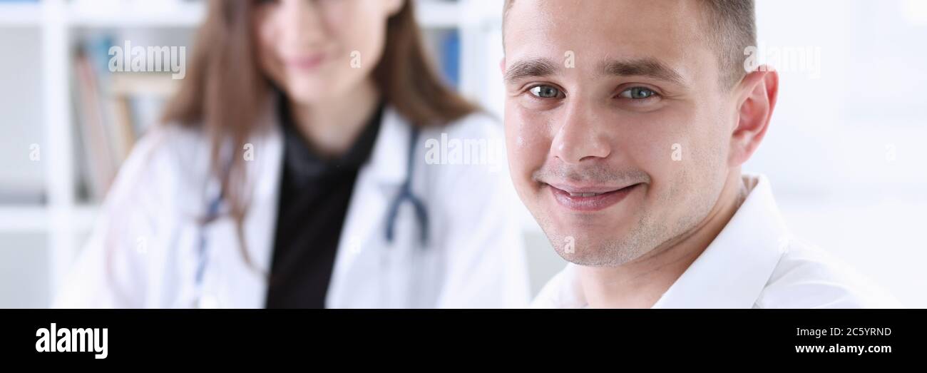 Satisfied happy handsome smiling male patient with doctor Stock Photo ...