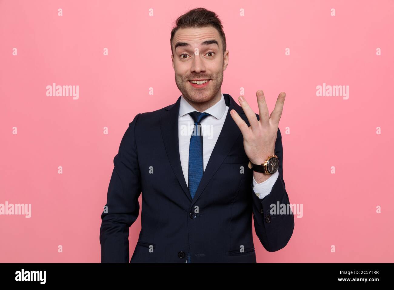 enthusiastic elegant man holding fingers up and gesturing, smiling and ...