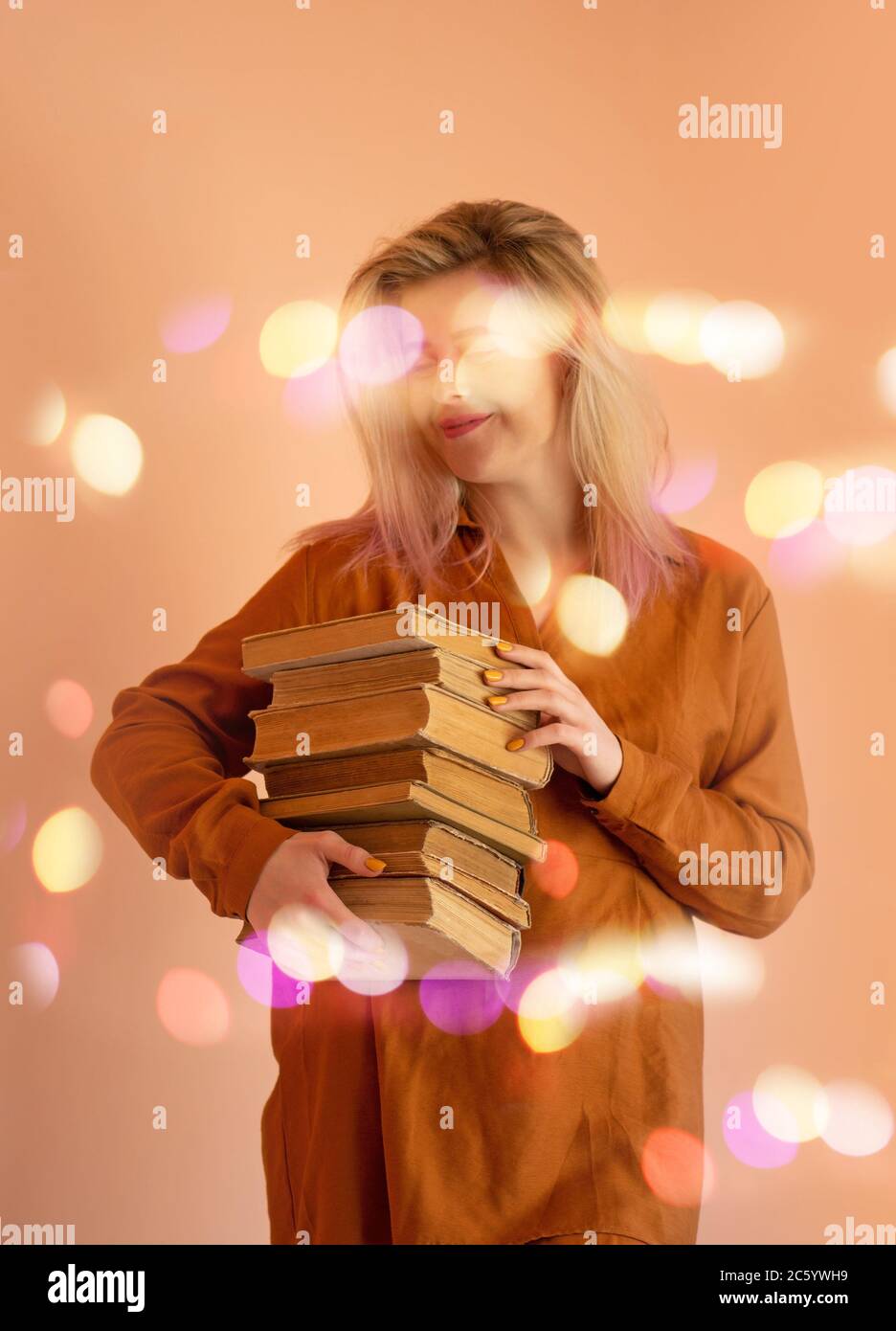 Happy casual girl holding stack color book. Student standing with books ...