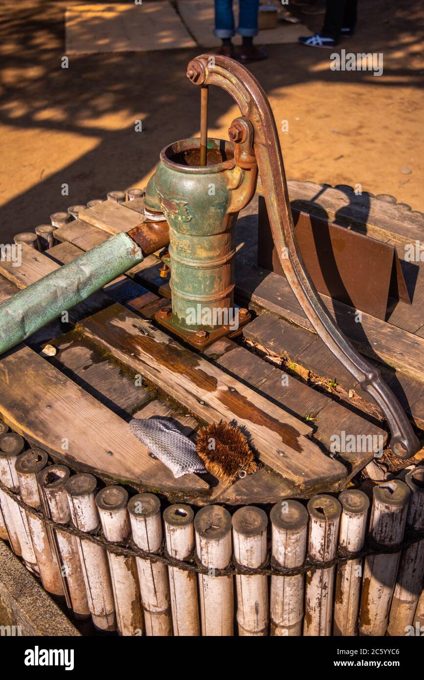 An old-fashioned water pump in the yard of a traditional Japanese ...