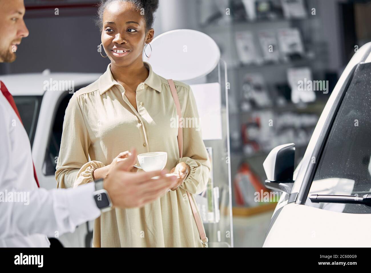 friendly caucasian salesman talks with black customer woman ...