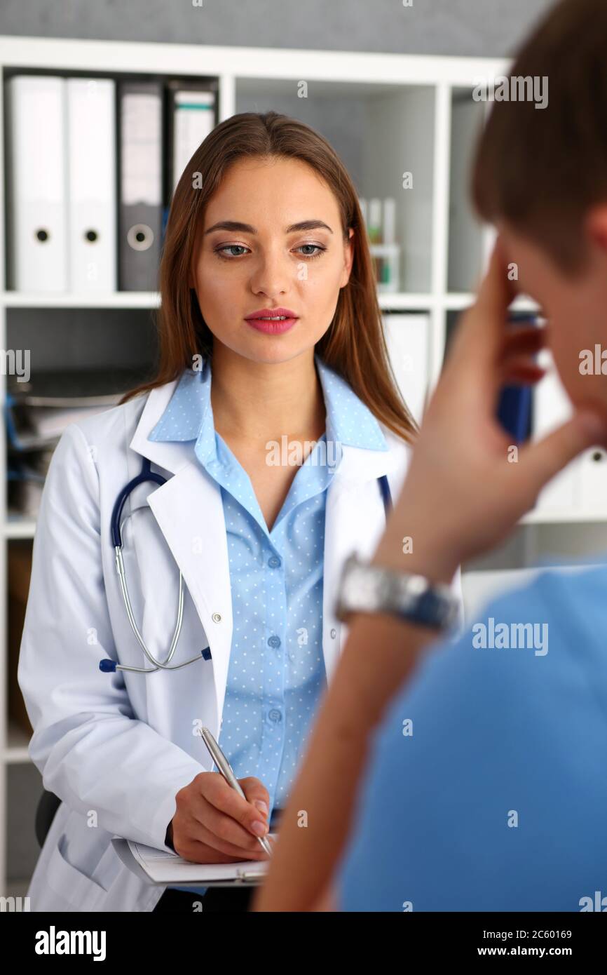 Doctor in consultation concerned patient hi-res stock photography and ...