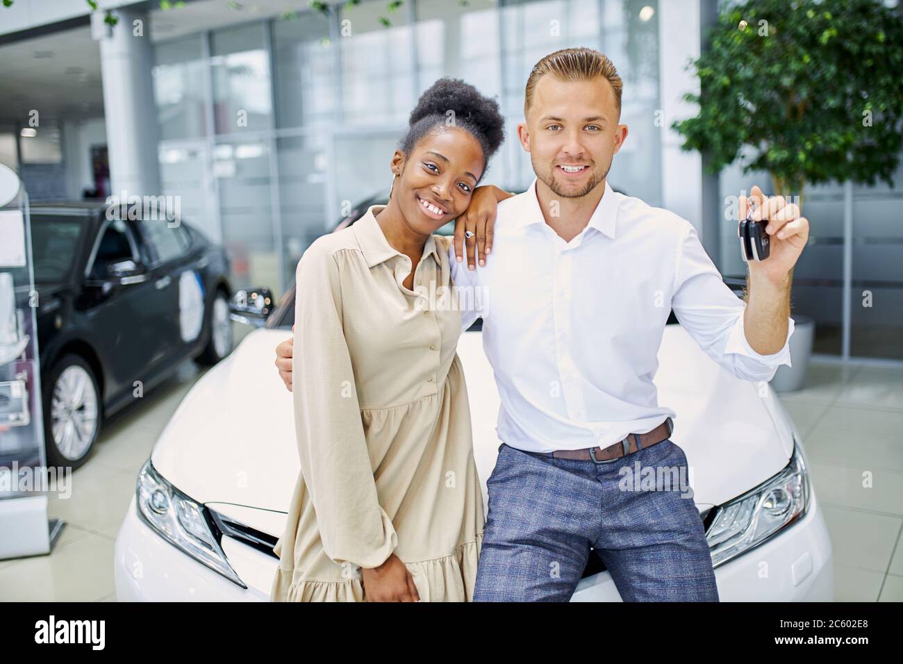 cute diverse couple in dealership, attractive black woman and caucasian ...