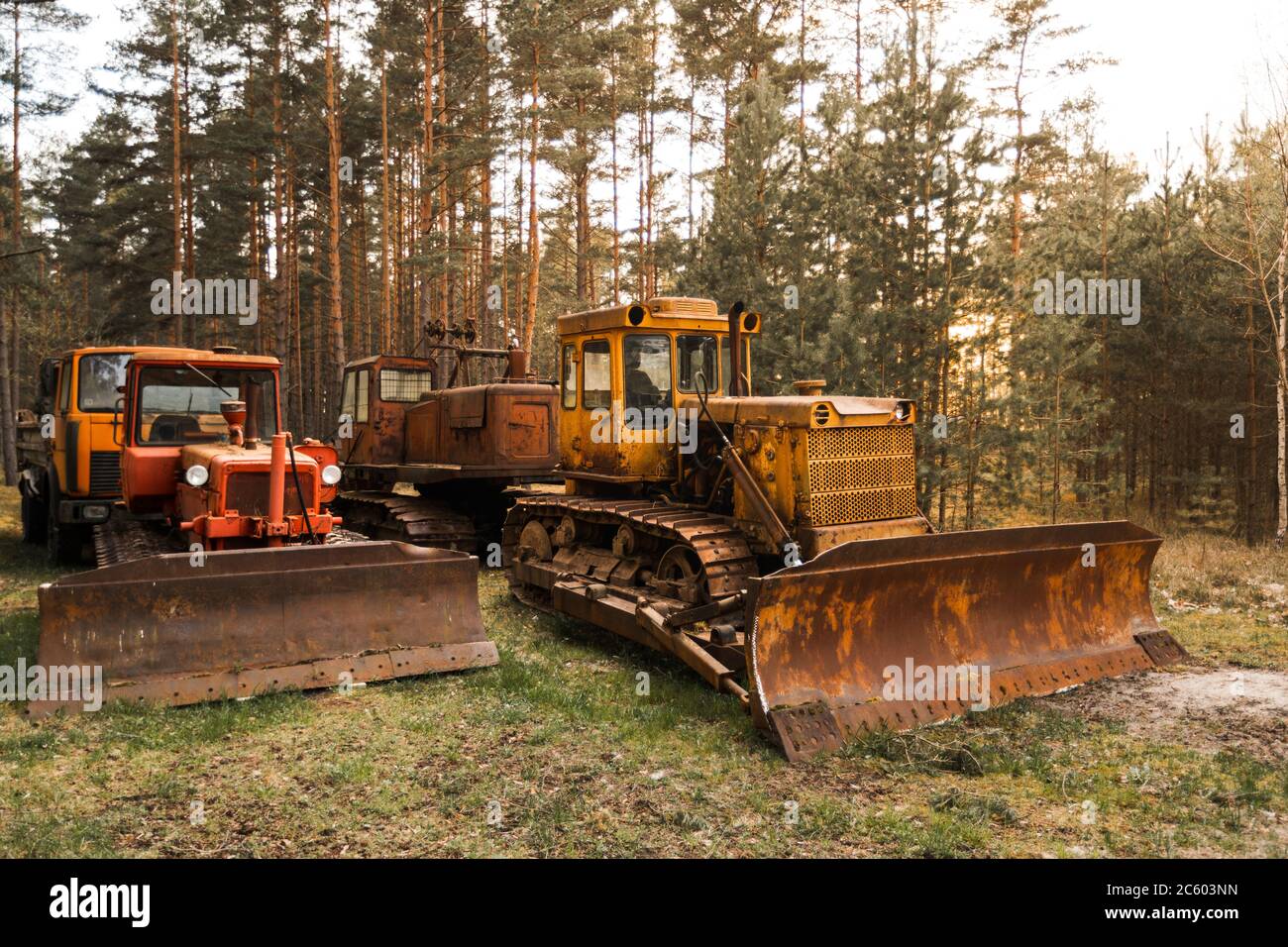 Old rusty abandoned tractors with huge loader buckets Stock Photo - Alamy