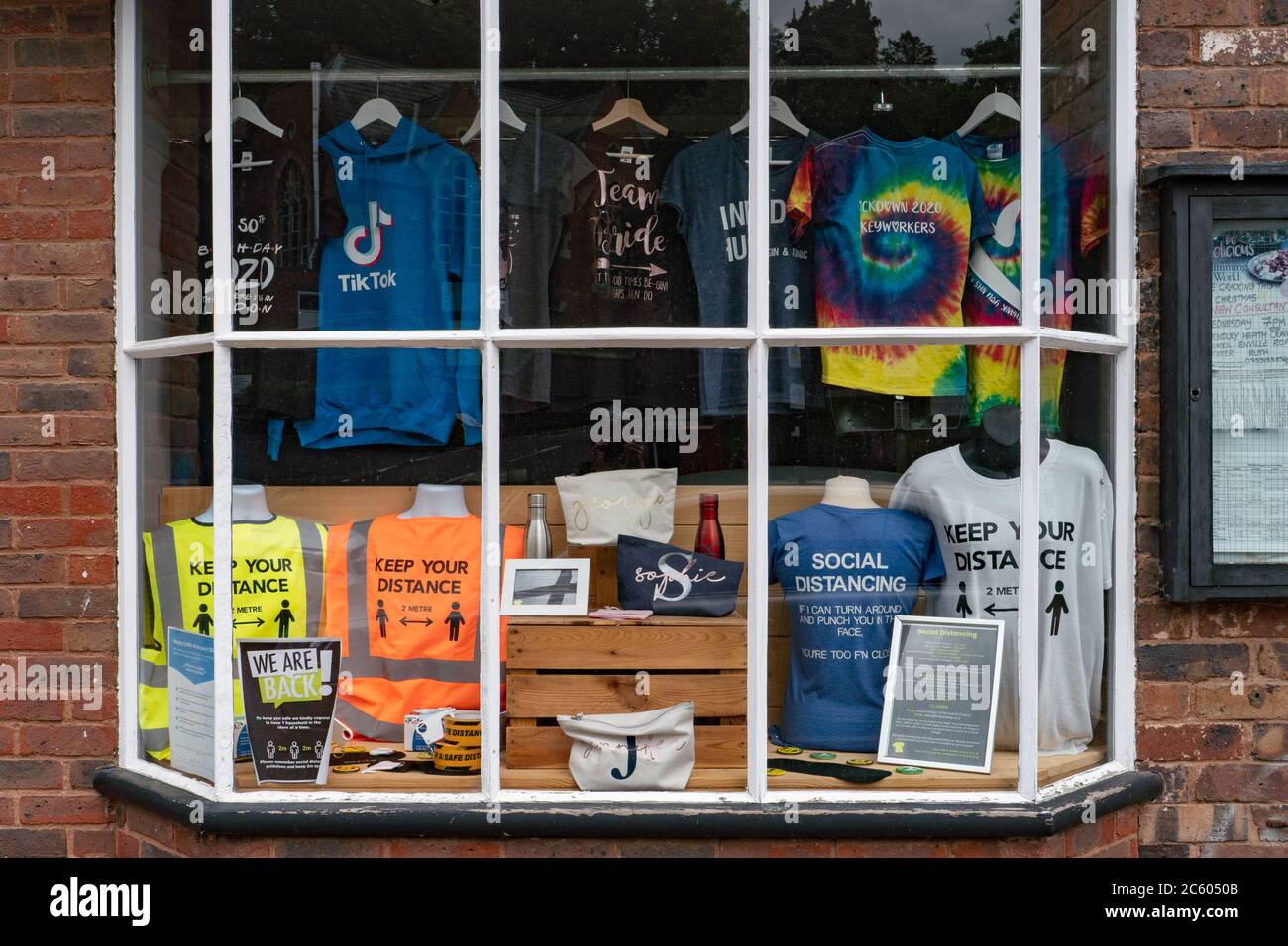 Shop window selling clothing printed with Keep Your Distance ...