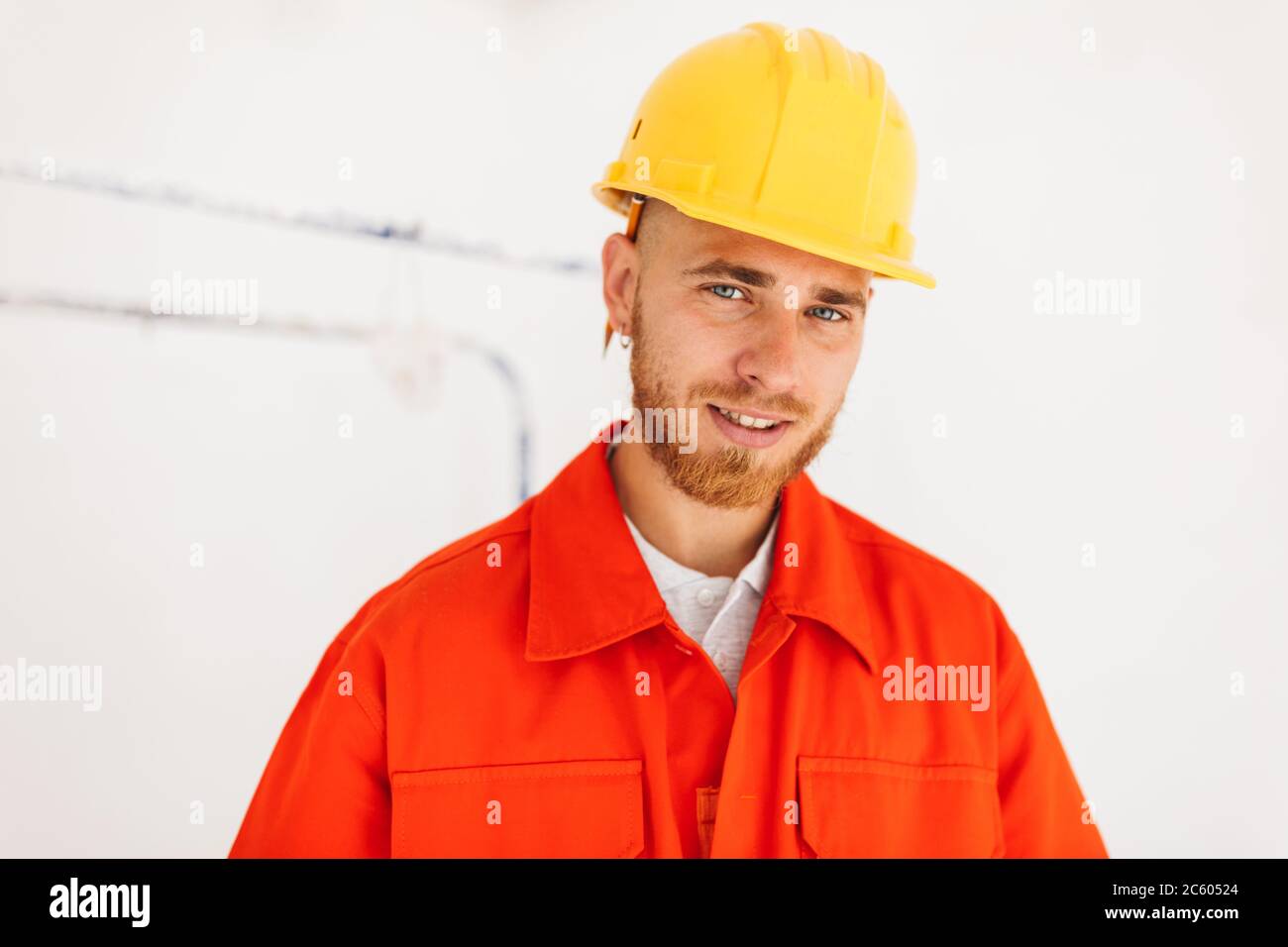 Smiling handyman in orange hi-res stock photography and images - Alamy