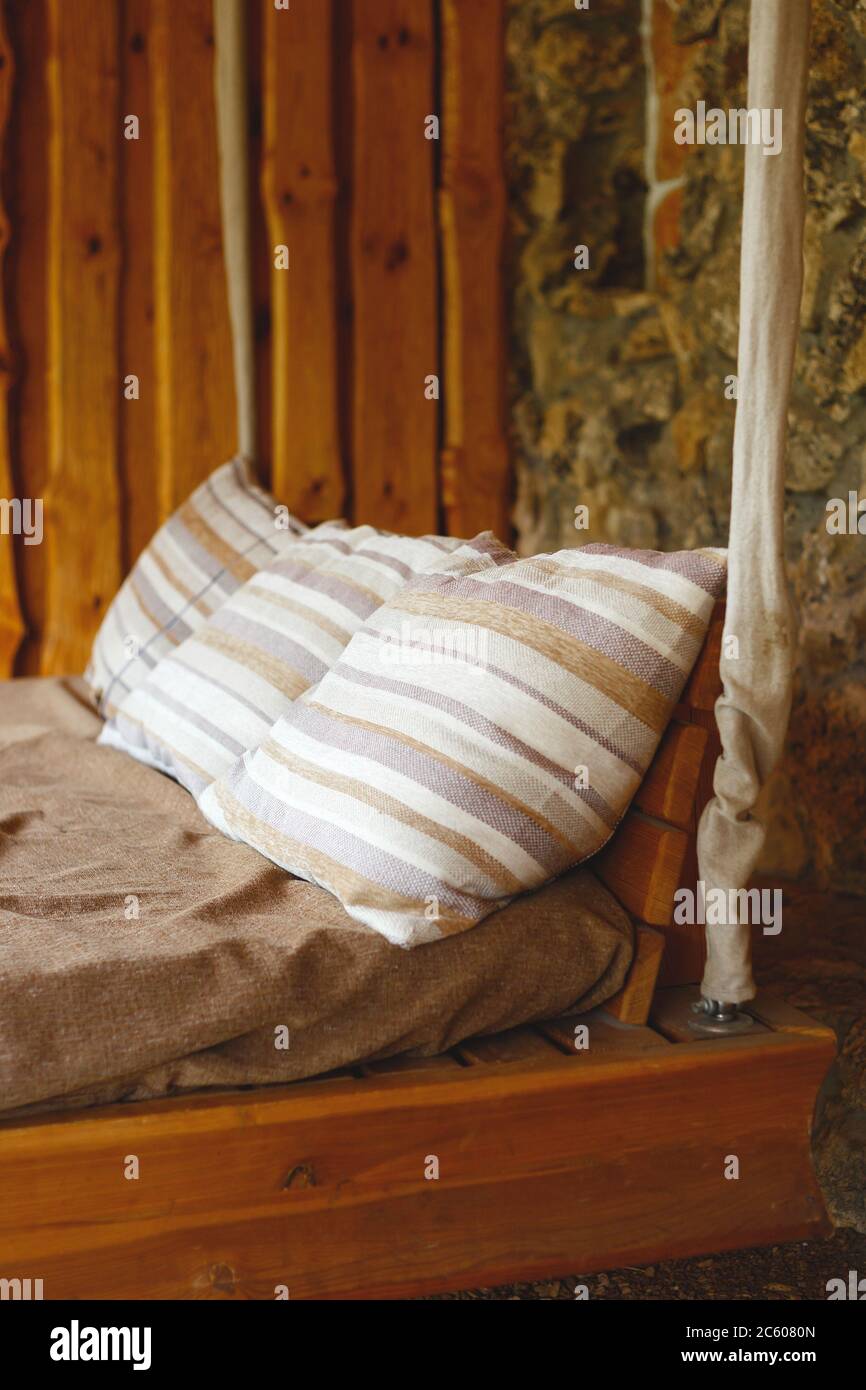 rest zone. rustic wooden hanging bed outdoors Stock Photo - Alamy