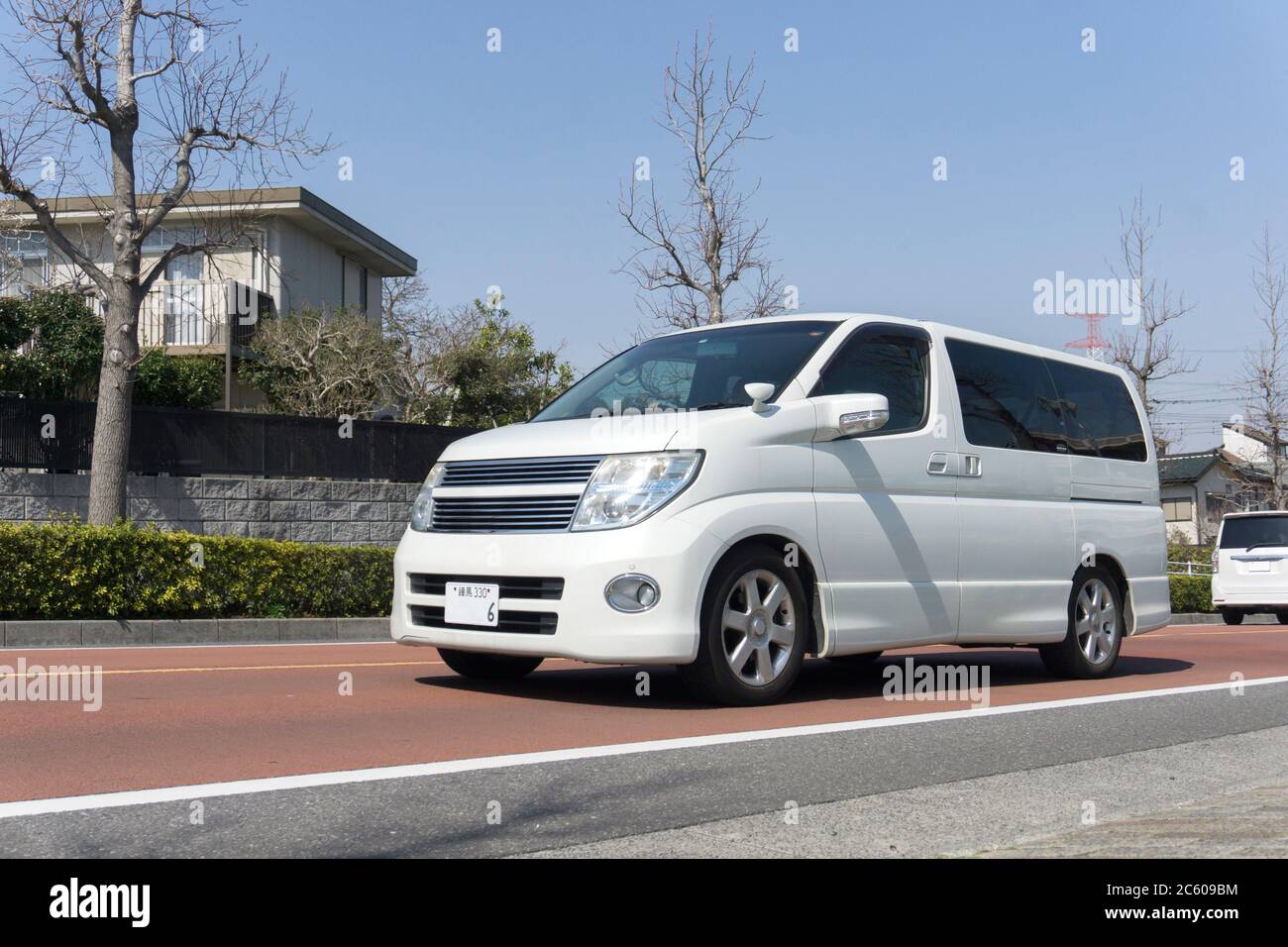 White minivan going on road Stock Photo - Alamy