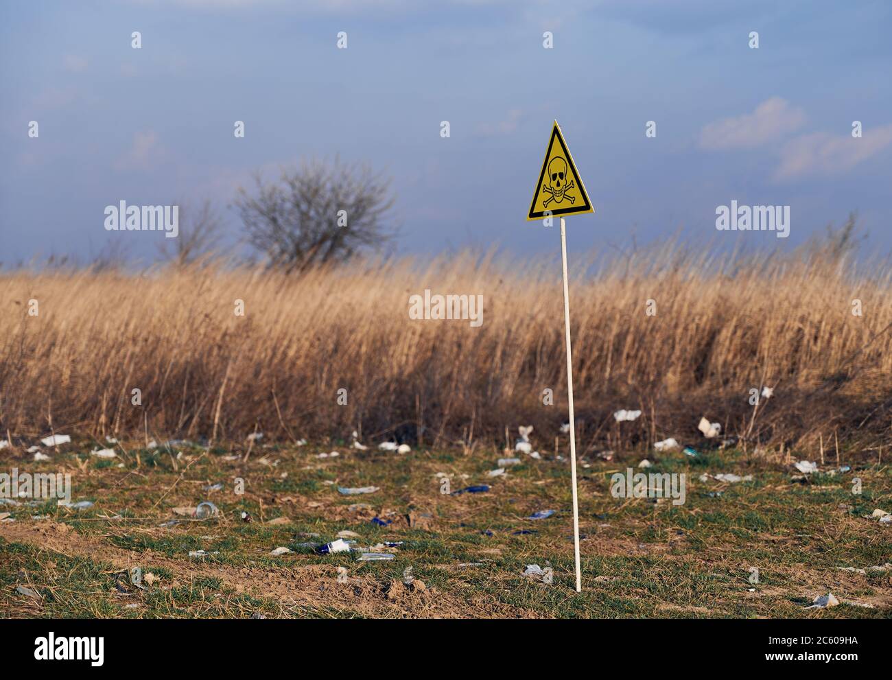 Yellow triangle with skull and crossbones symbol on abandoned territory ...