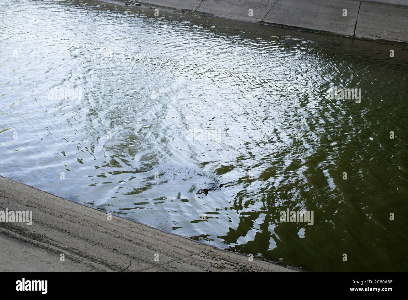 stream flowing through concrete embankment Stock Photo - Alamy