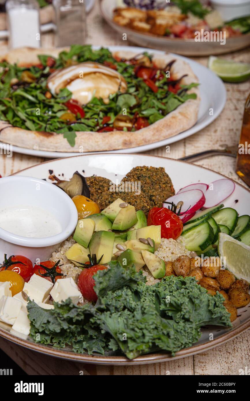 Healthy dishes with fresh ingredients on restaurant table. Vegan ...