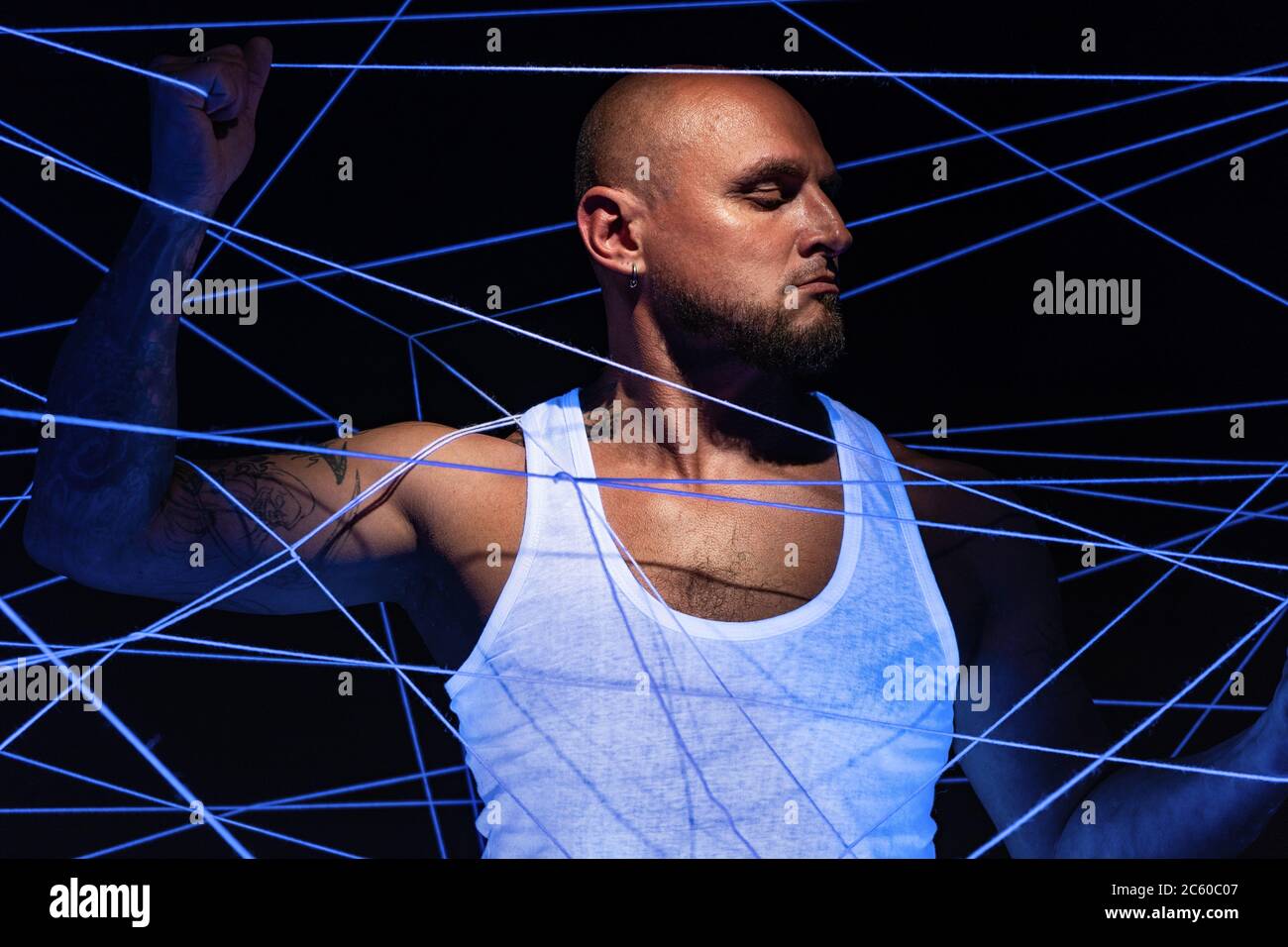 Portrait of bald man tangled in white threads Stock Photo - Alamy