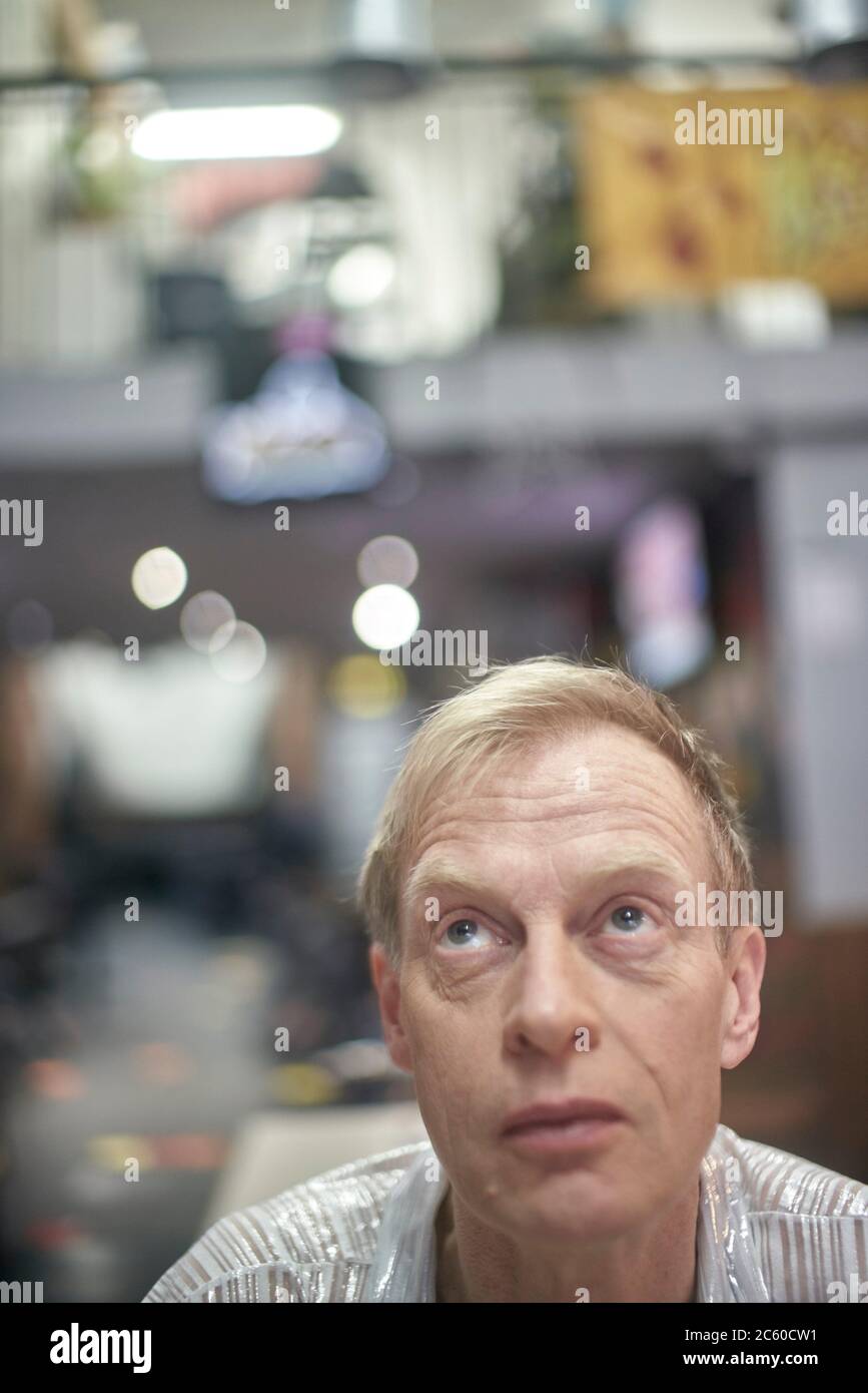 man peering up Stock Photo - Alamy