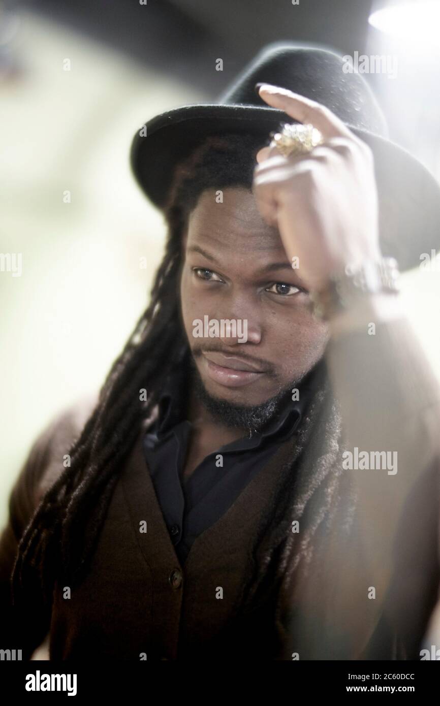 Young man dreadlocks black hat hi-res stock photography and images - Alamy