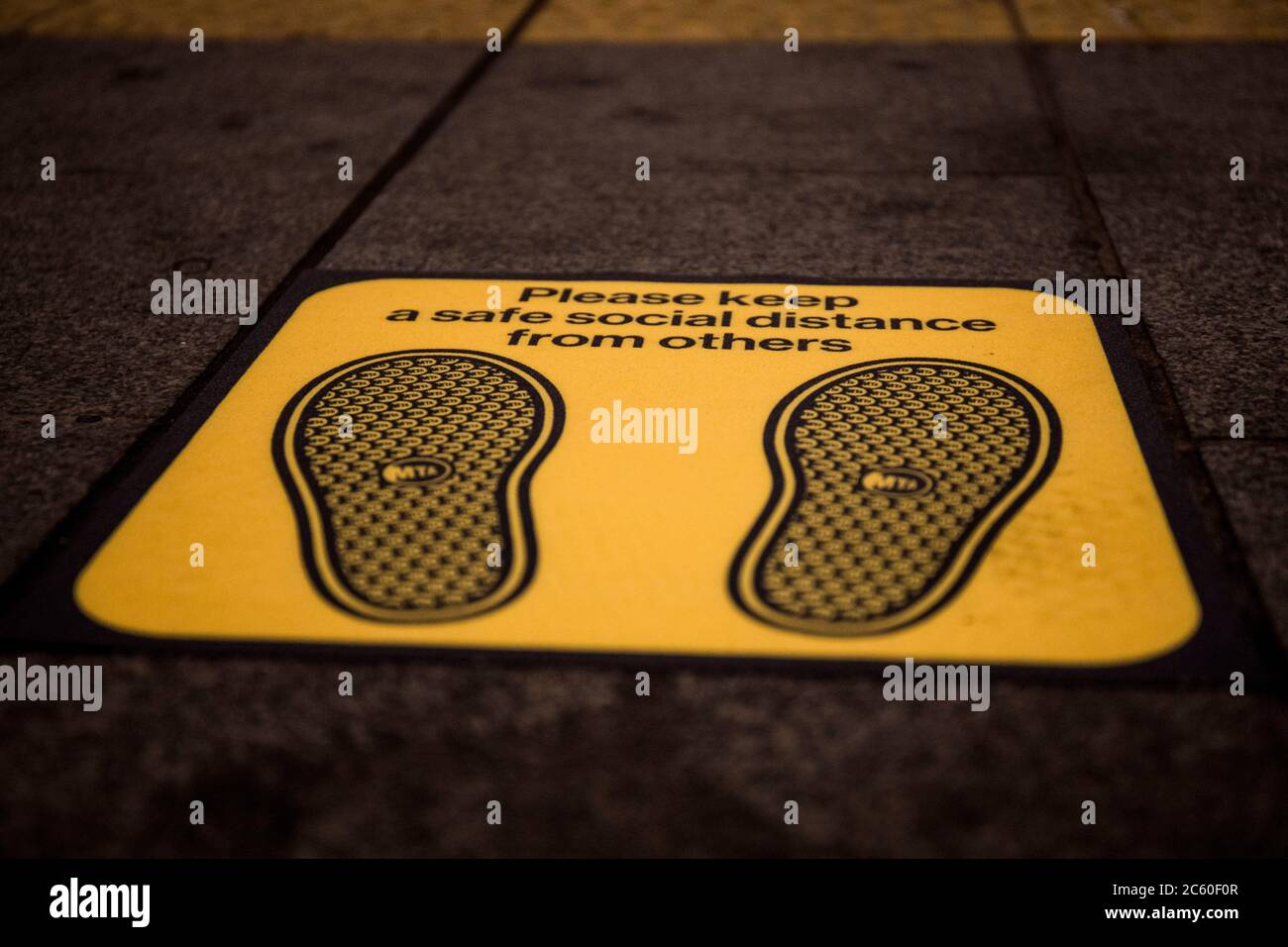 Safe social distance signs on the ground of the subway in New York City ...